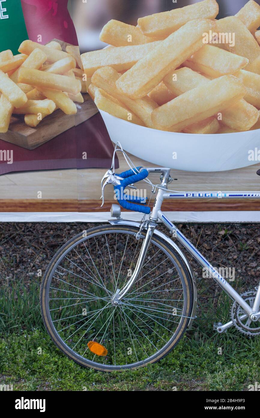 Old racing bike in front of French fries on a poster Stock Photo - Alamy