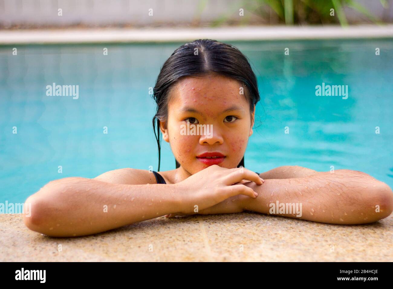 Girl standing poolside hi-res stock photography and images - Alamy