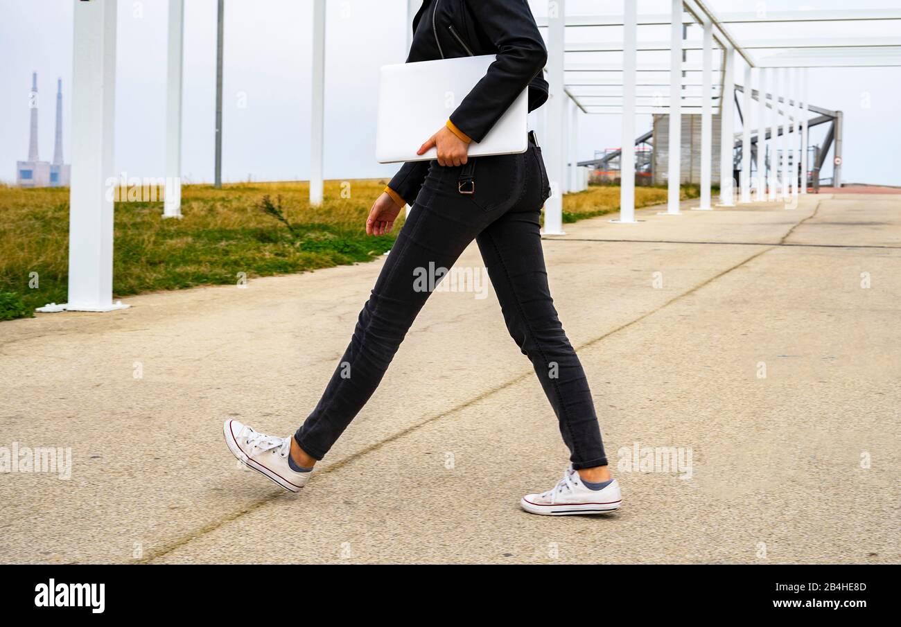 Business woman walking laptop hi-res stock photography and images - Alamy