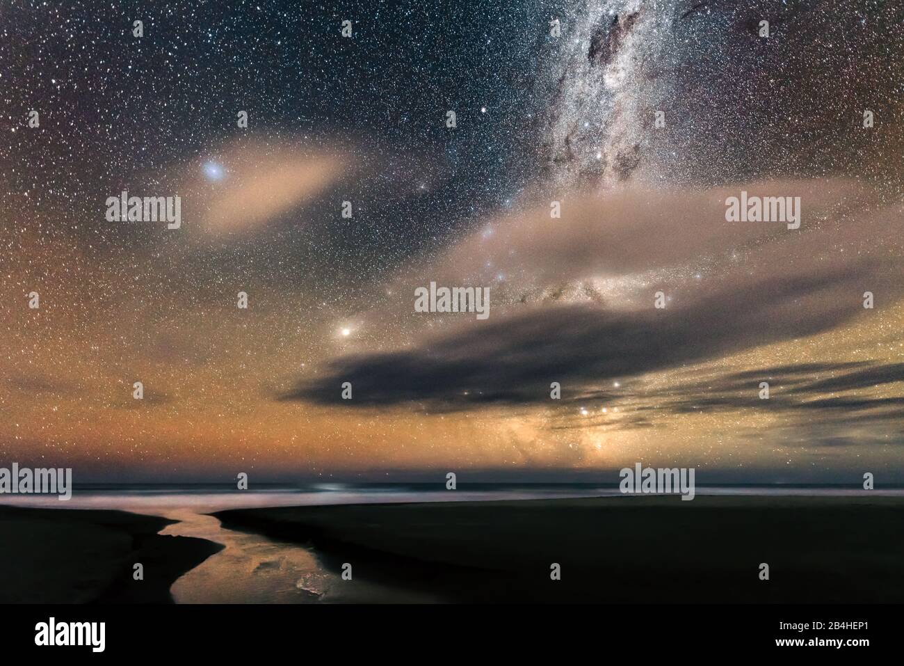 Starry night sky over New Zealand beach Stock Photo - Alamy