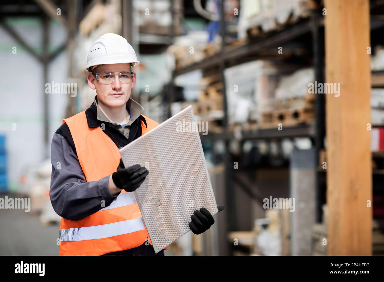 technician male working in a store watching to product Stock Photo - Alamy