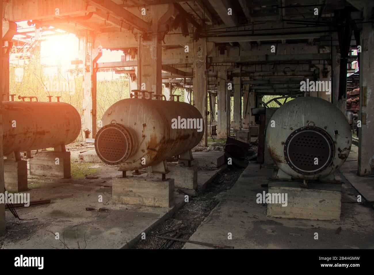 Old abandoned factory with rusty remains of equipment Stock Photo - Alamy