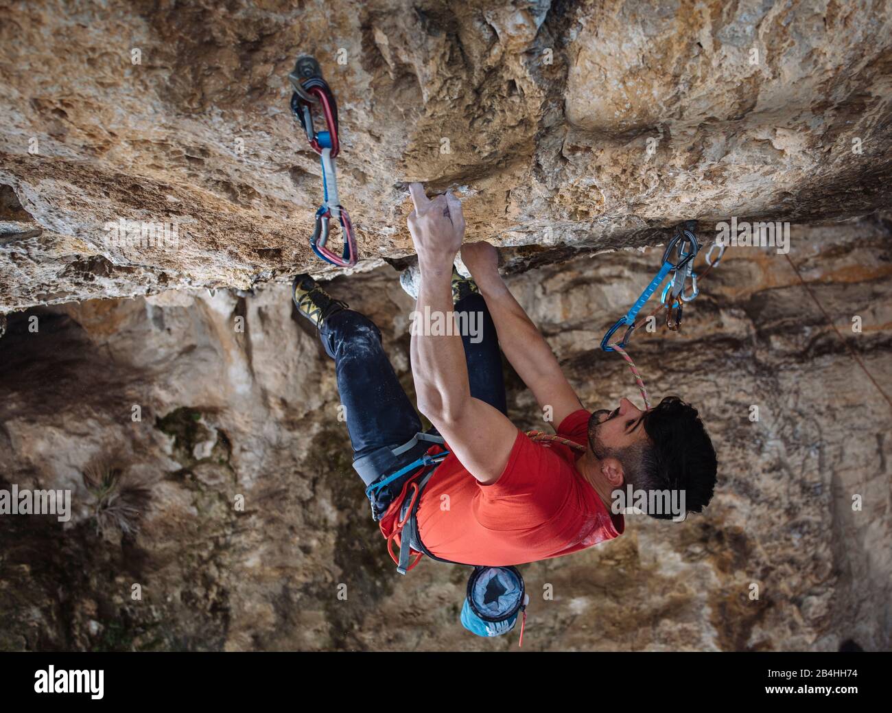 Aerial view of a climber on a hard sport climbing route in a cave Stock ...