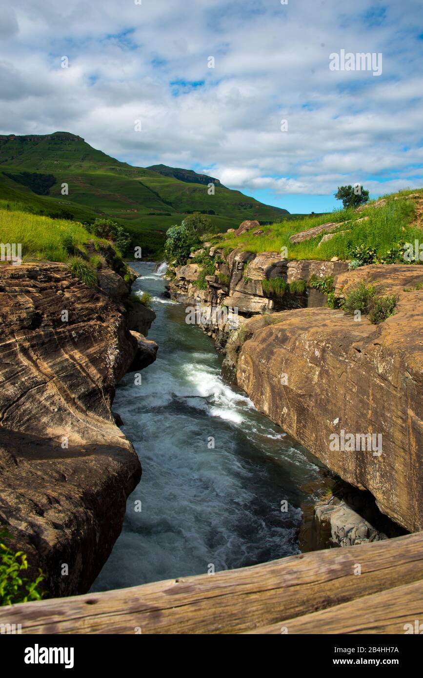 wooden footbridge over rapids of mnweni river, northern drakensberg ...