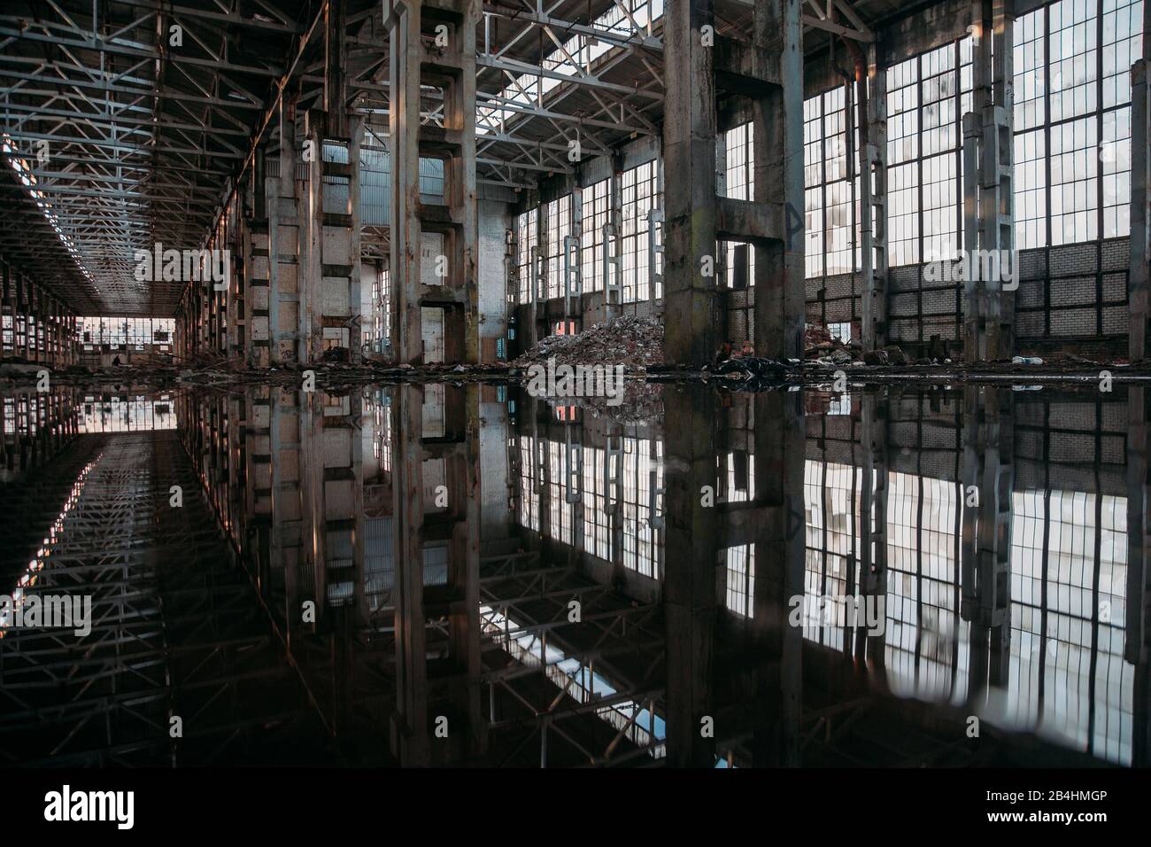 Inside of flooded dirty abandoned ruined industrial building with water ...