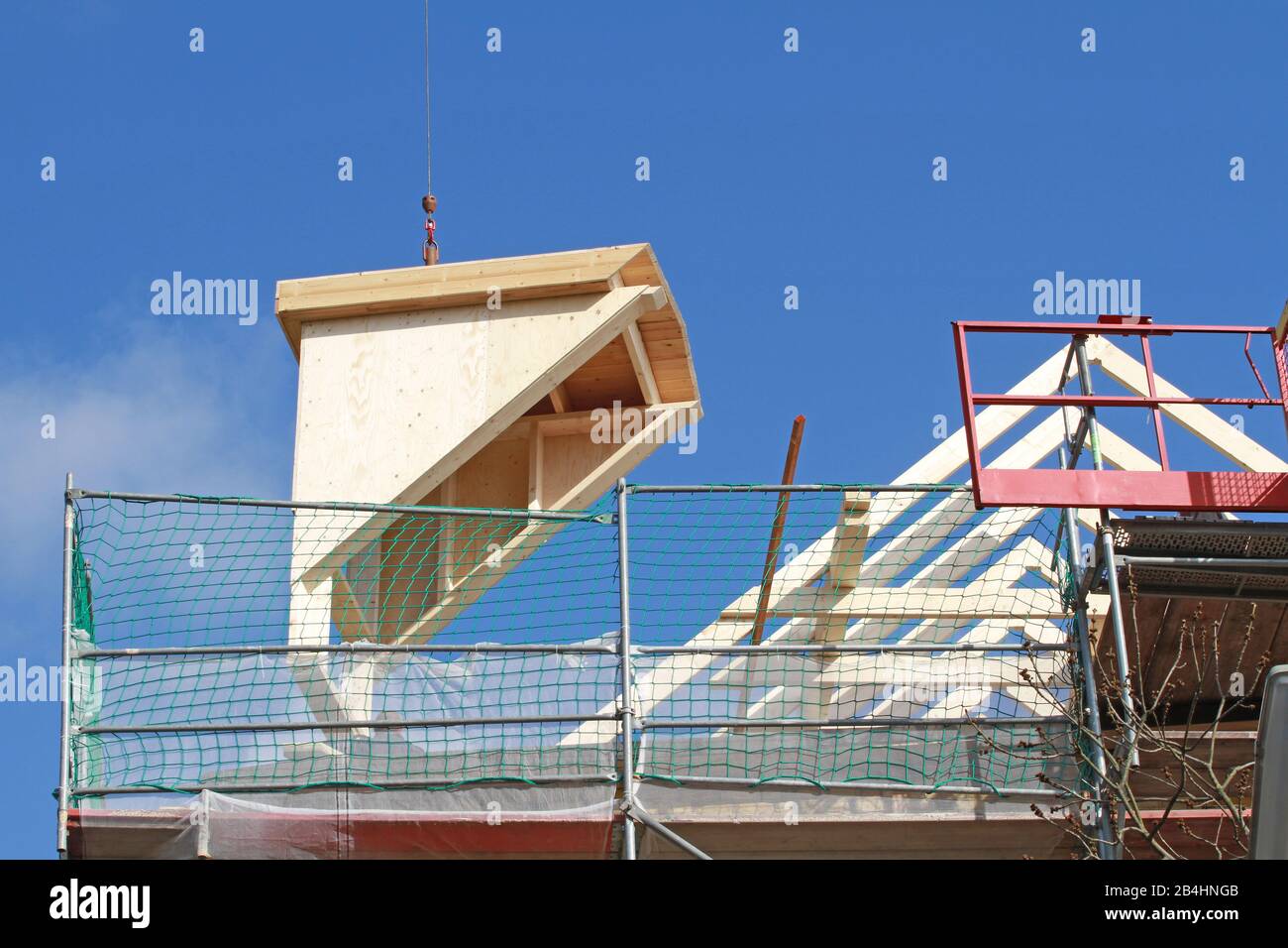 dormer installation on rooftop of apartment building Stock Photo - Alamy