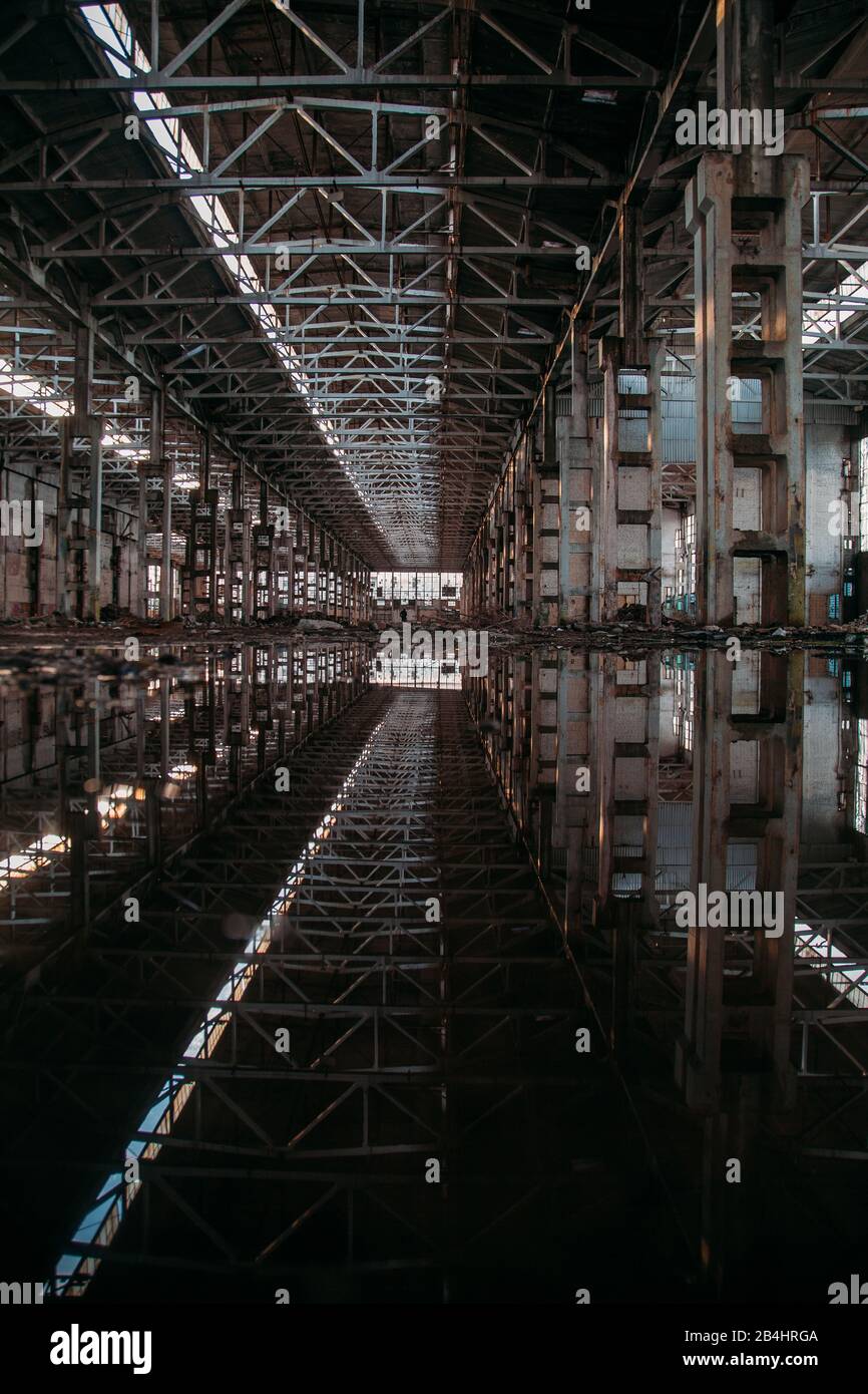 Inside of flooded dirty abandoned ruined industrial building with water ...