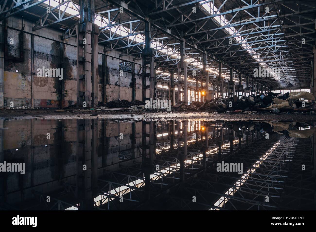 Inside of flooded dirty abandoned ruined industrial building with water ...