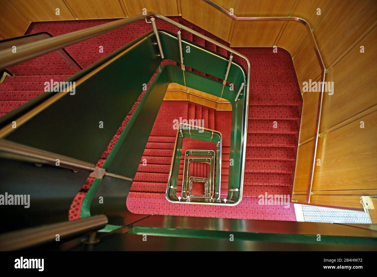 Wood-paneled spiral staircase in the hotel and museum ship Queen ...