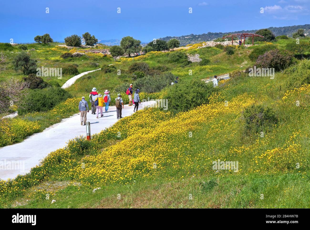 Spring landscape with tourist group in the antique archaeological site ...