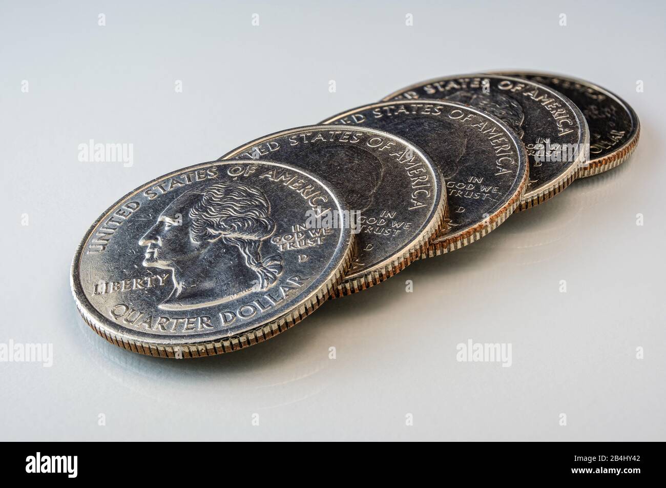A stack of coins -quarters- in close-up in a white background Stock ...