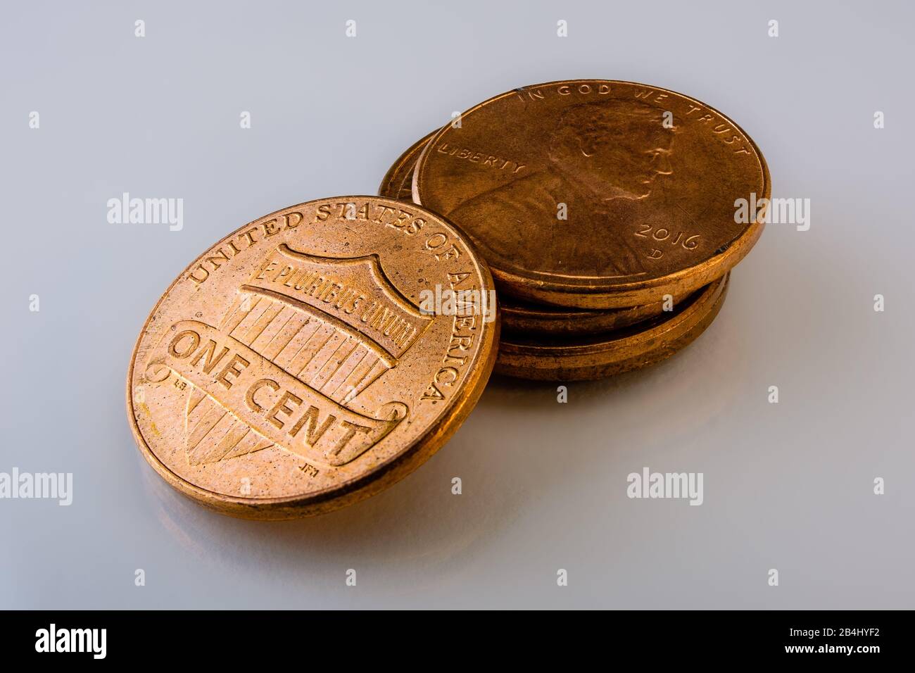 A stack of coins -pennies- in close-up in a white background Stock ...