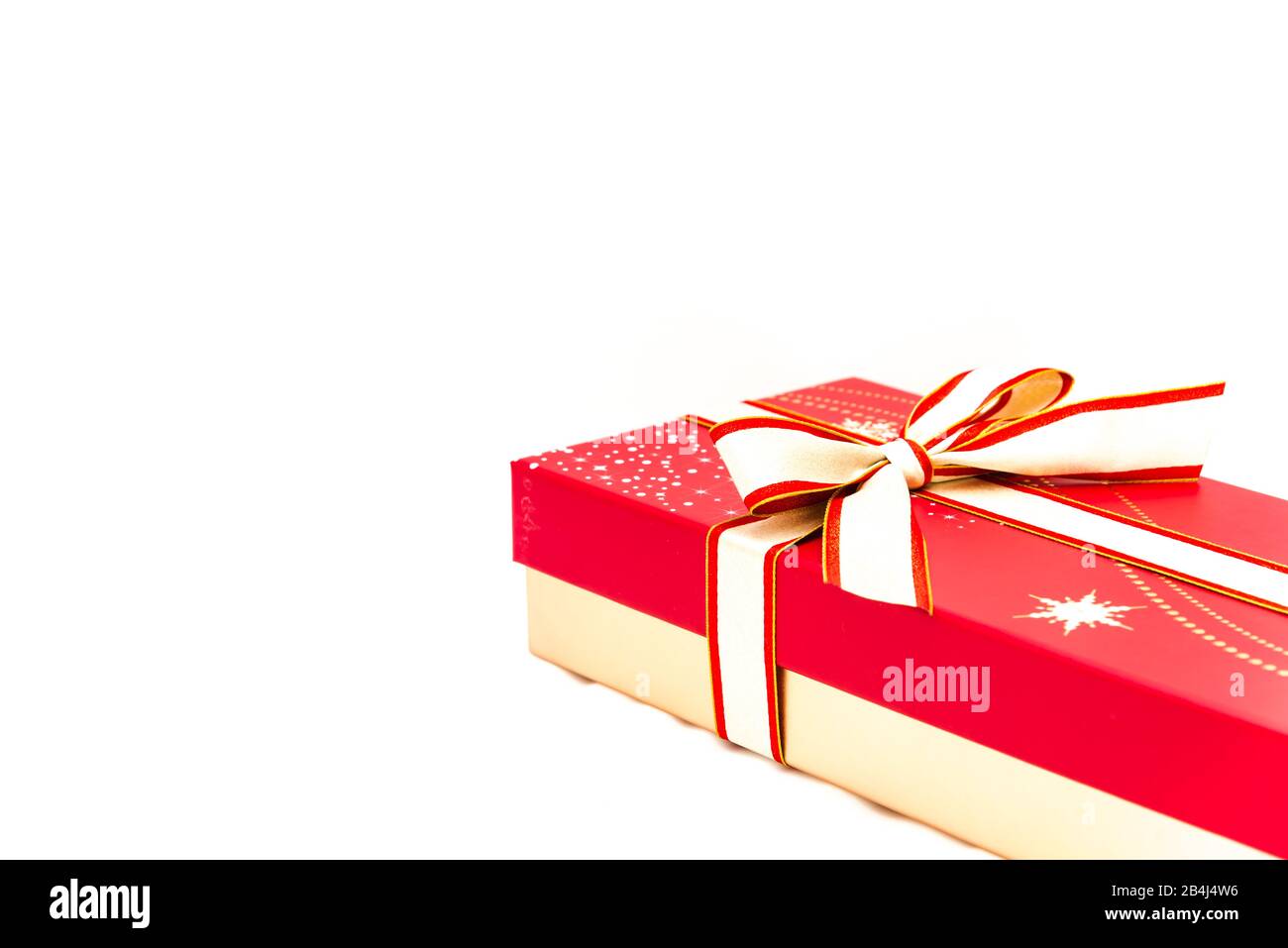 Studio shot chocolate box with red bow ribbon isolated on white close ...