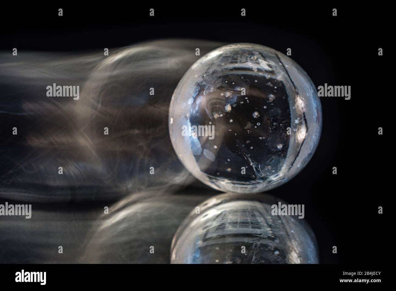 A single marble in motion in a black background Stock Photo - Alamy