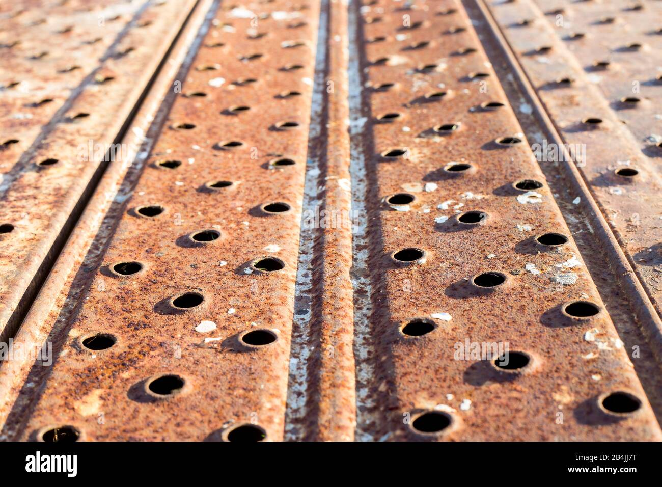 rusty yellow iron sheets with holes. selective focus . For background ...