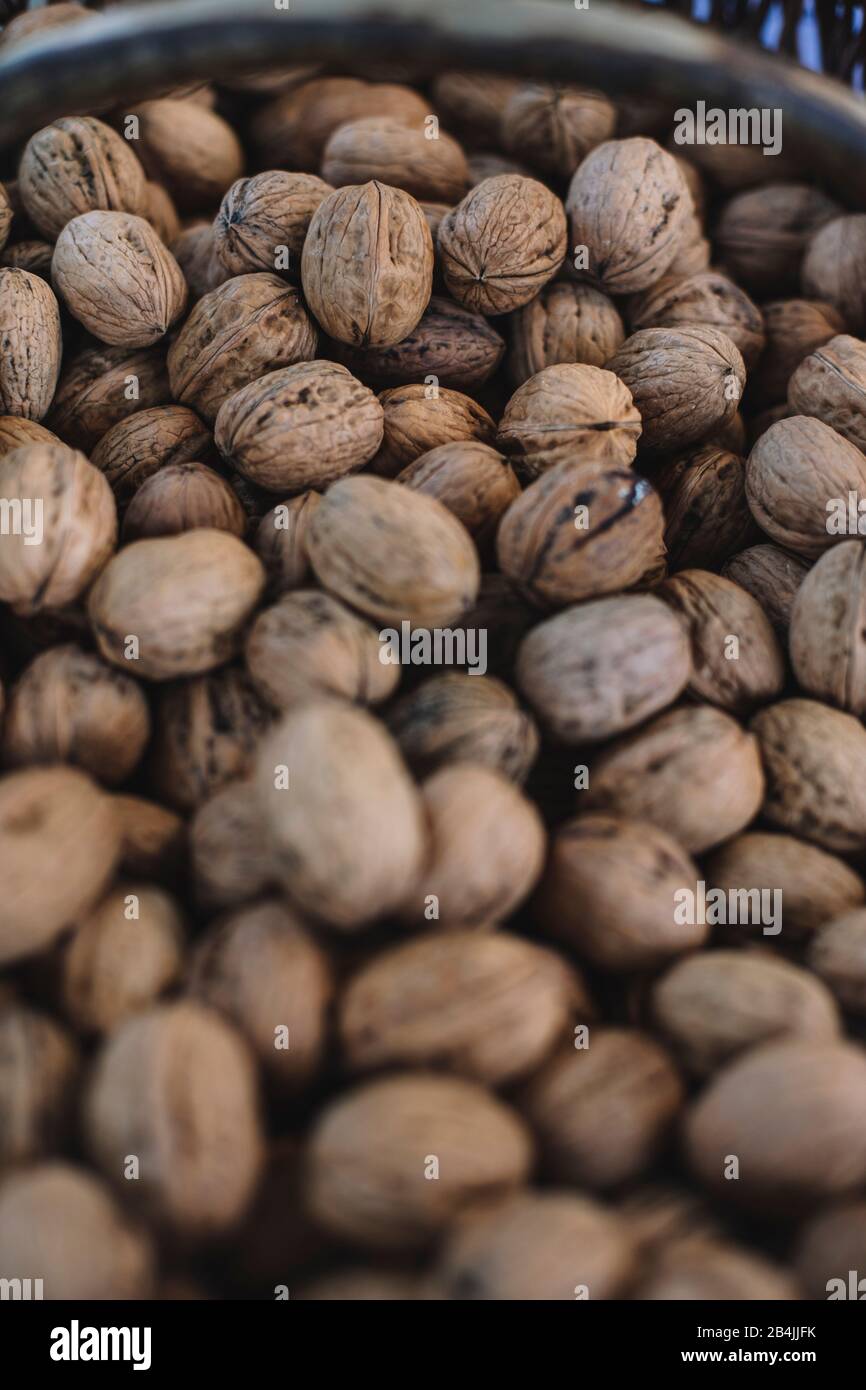 Lots of walnuts on market stall for sale Stock Photo - Alamy