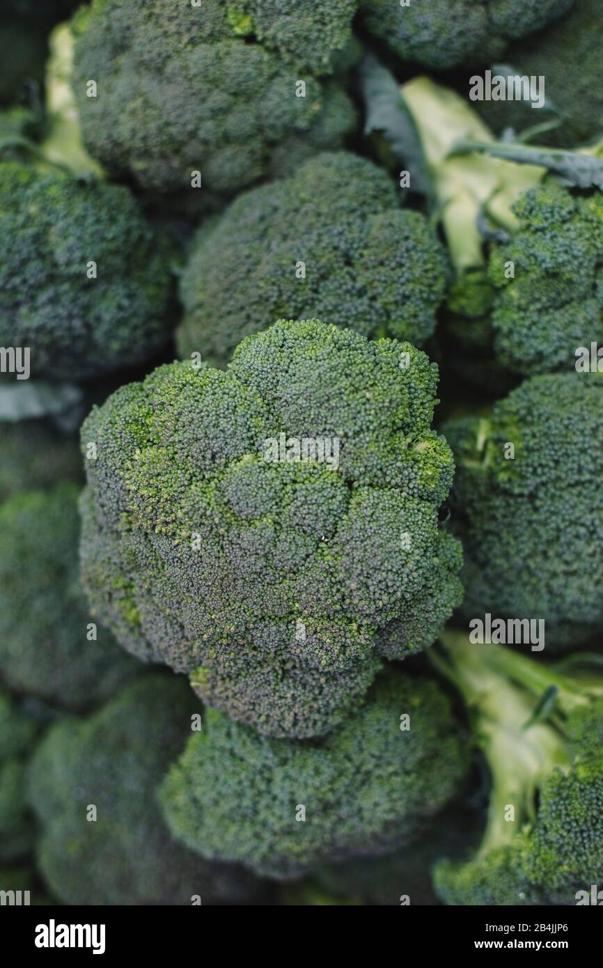 Broccoli on pile for sale, close-up Stock Photo - Alamy