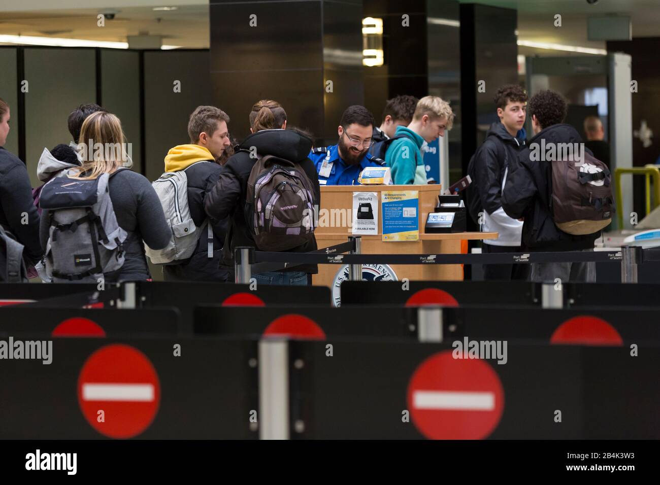 A TSA agent screens a passenger at a security checkpoint in the Central ...