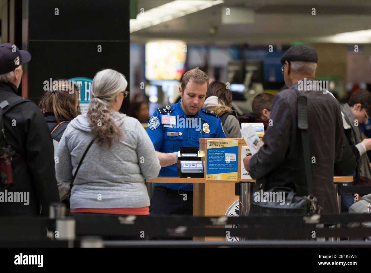A TSA agent screens a passenger at a security checkpoint in the Central ...