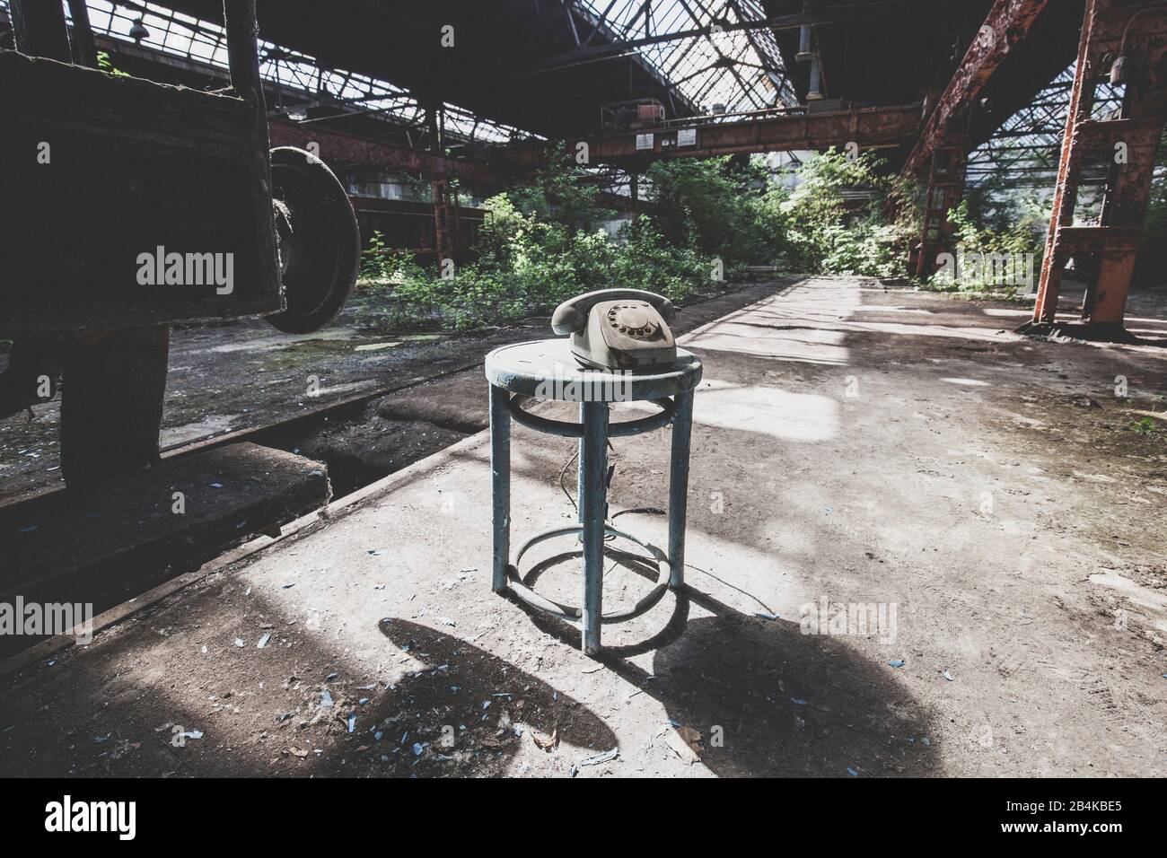 old telephone on stool in abandoned factory Stock Photo - Alamy