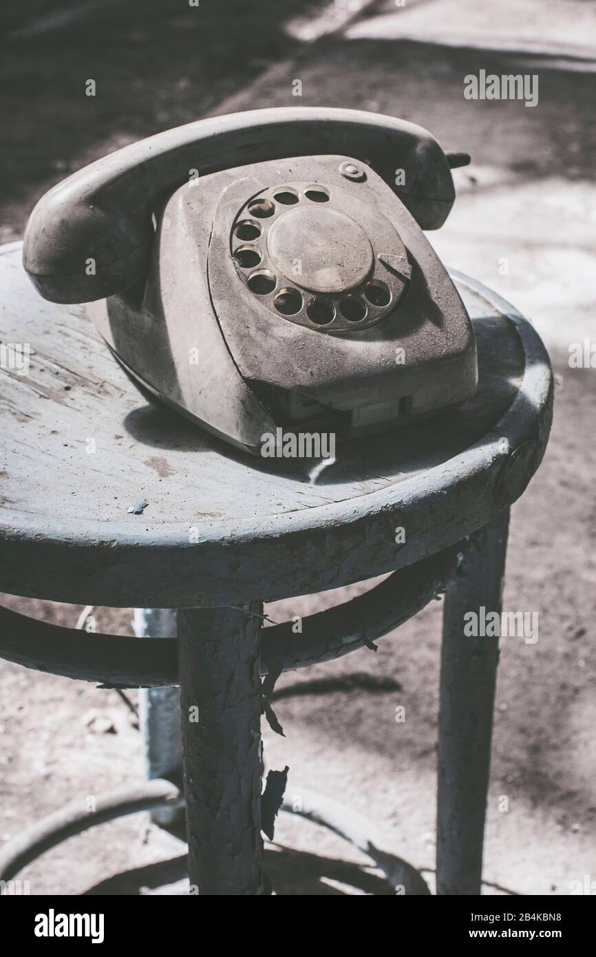 Dusty old telephone on stool Stock Photo - Alamy