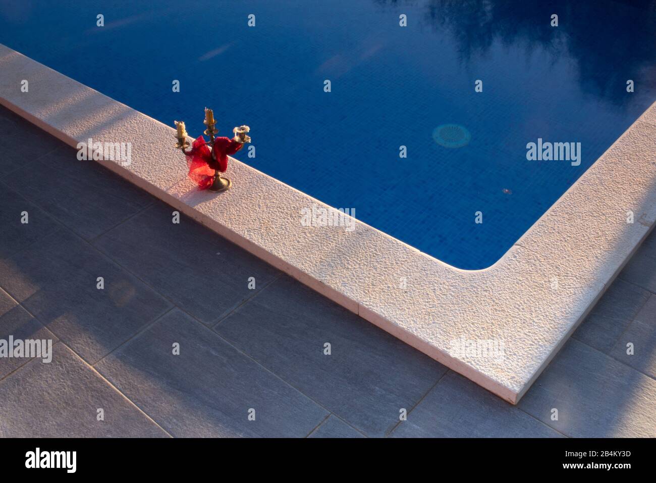 Candlestick by the pool in the sunrise Stock Photo - Alamy