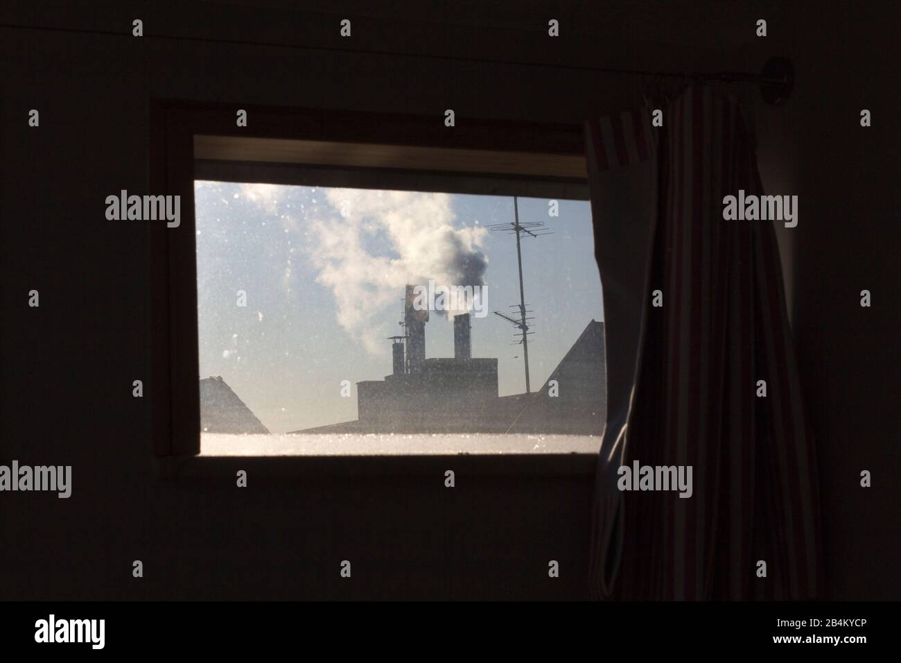 View of roofs and chimneys from small windows Stock Photo - Alamy