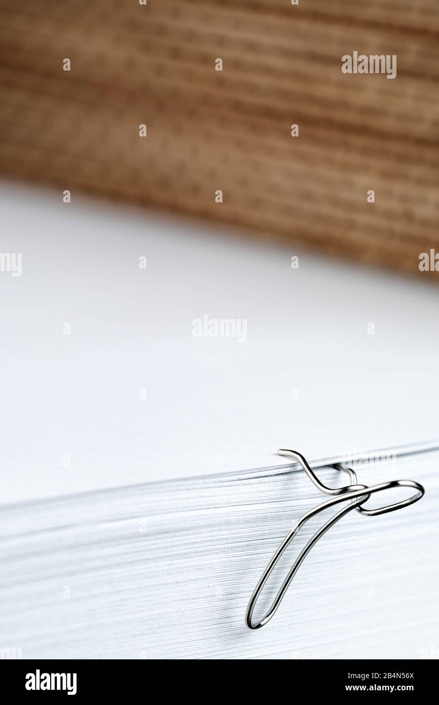 Paper clip climbs a stack of paper hi-res stock photography and images ...