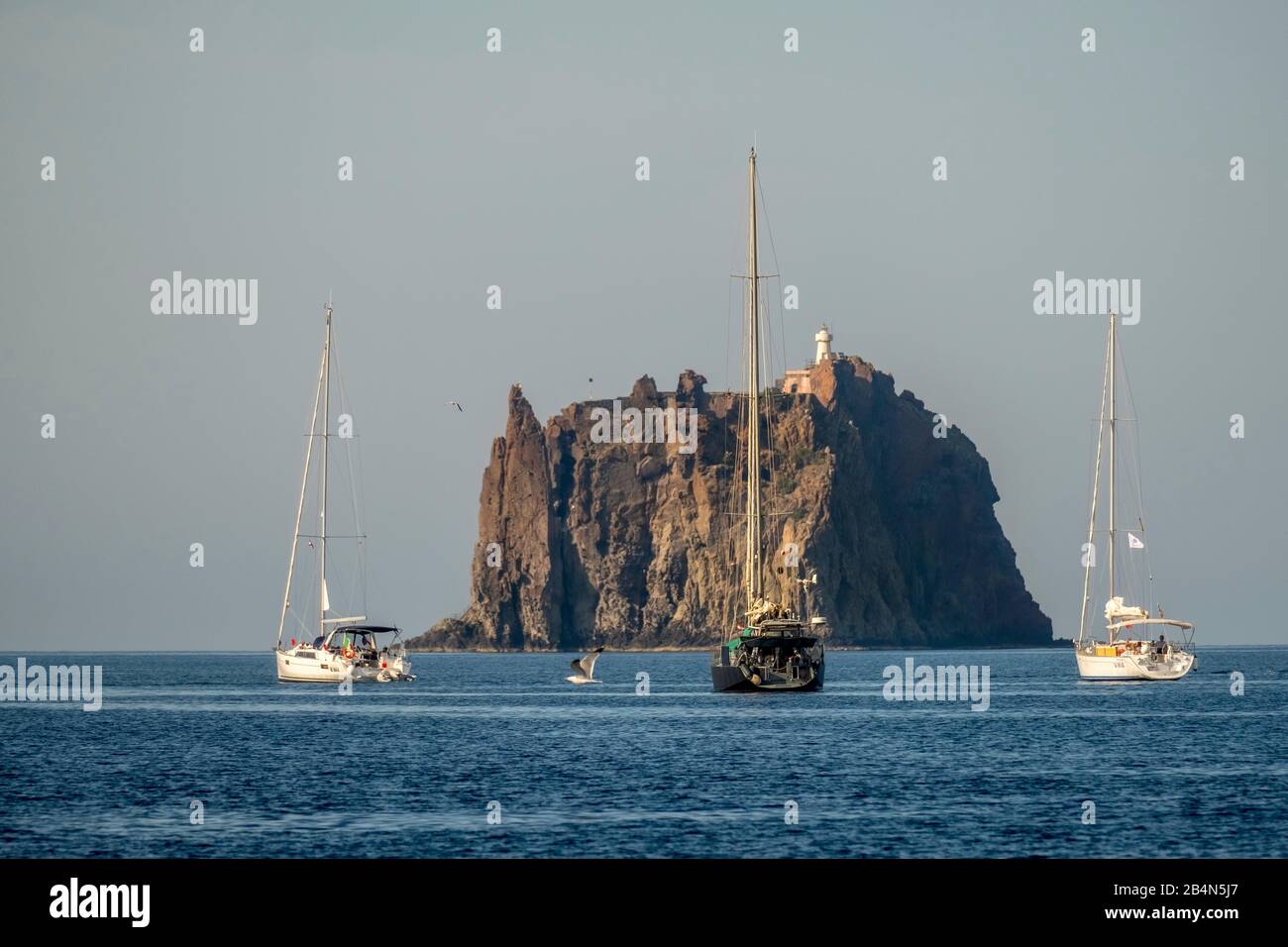 Strombolicchio, the tower-like cliff in front of the Stromboli volcano ...