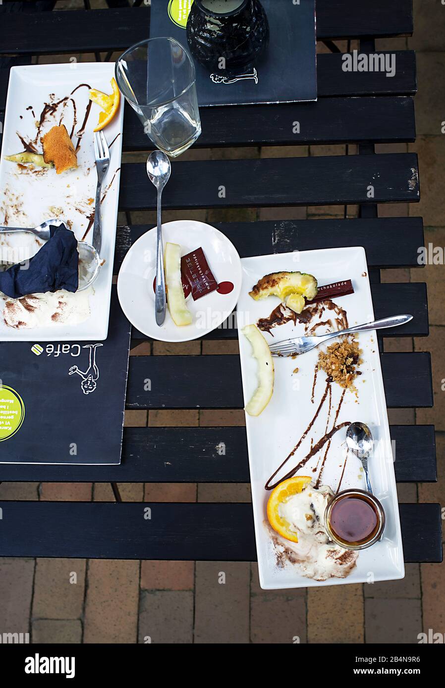Table with plates and cutlery, leftovers, food, eaten Stock Photo - Alamy