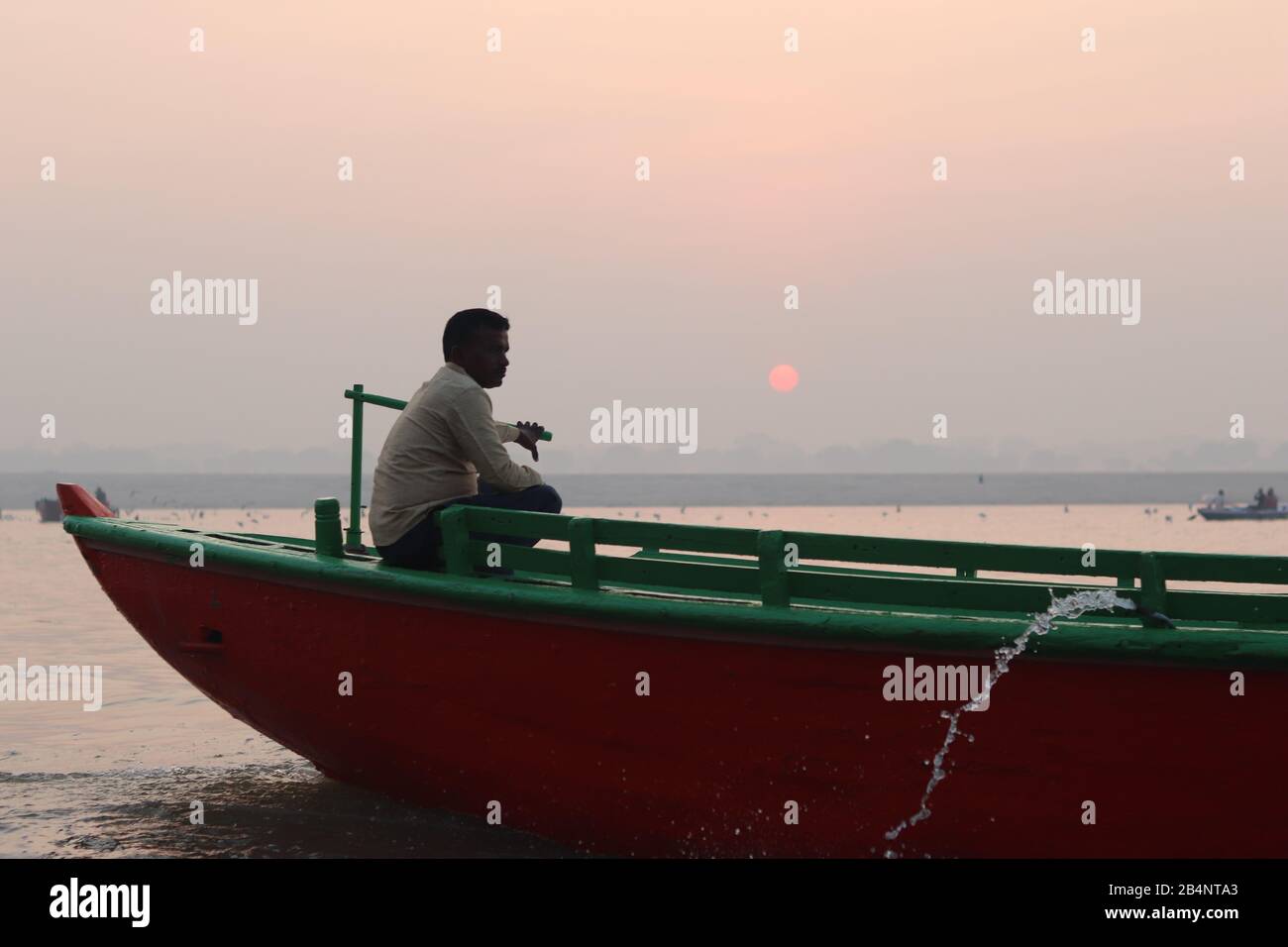 Boatman on his boat Stock Photo - Alamy