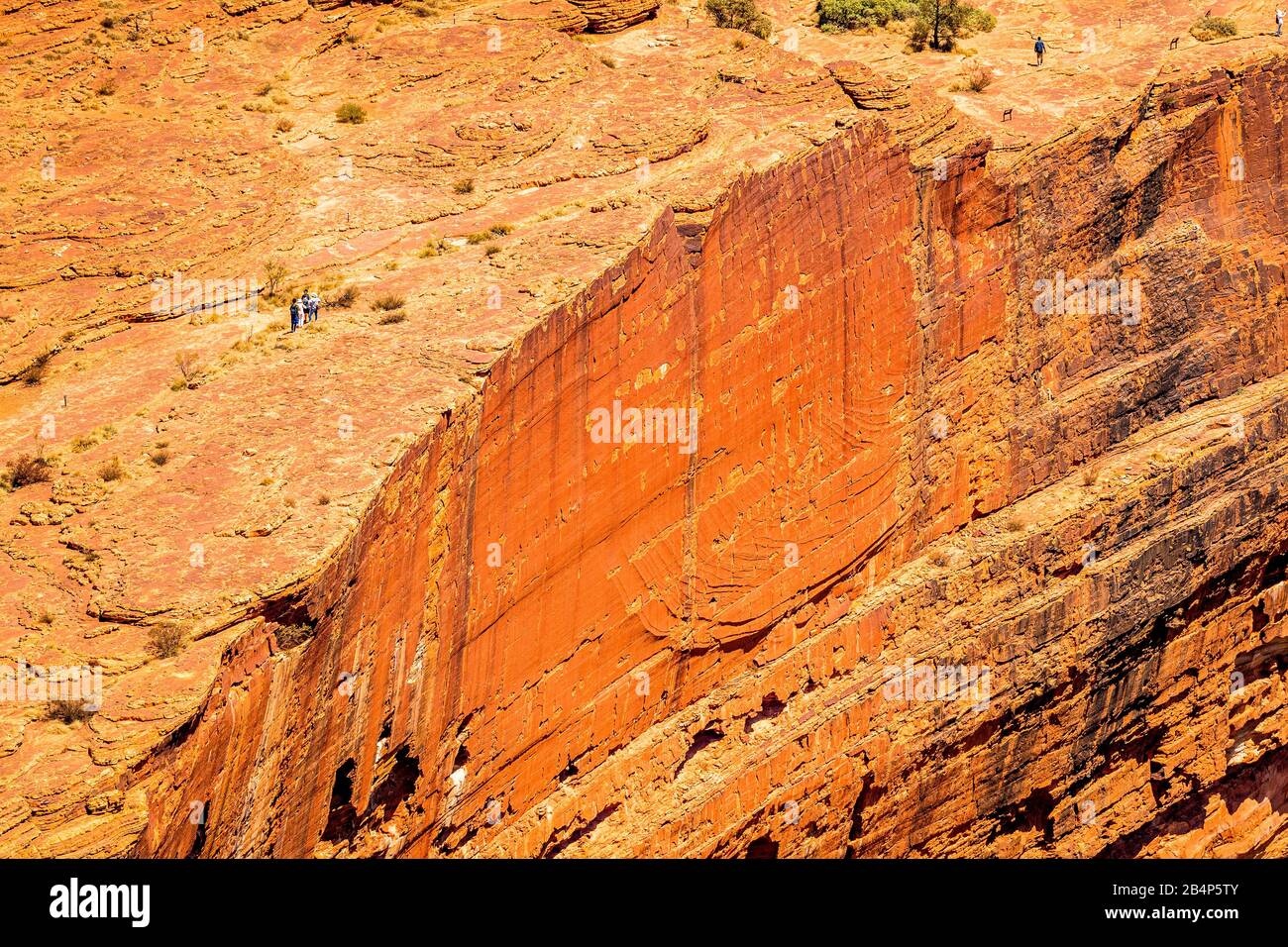 The giant rim wall of Kings Canyon and hikers demonstrate the scale and ...