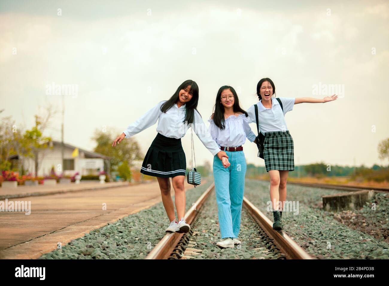 three asian teenager playing with happiness on railway track Stock ...