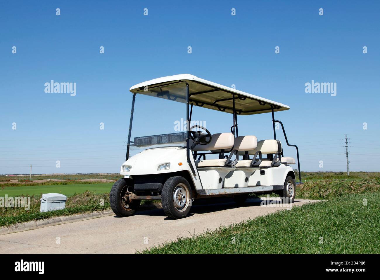 White golf carts at the green golf course Stock Photo - Alamy