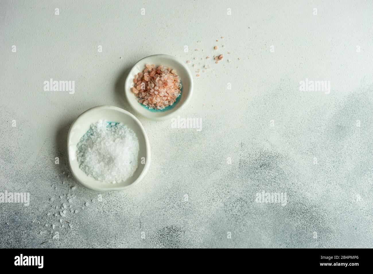 Organic food frame with sea salt and hymalayan salt on stone background ...
