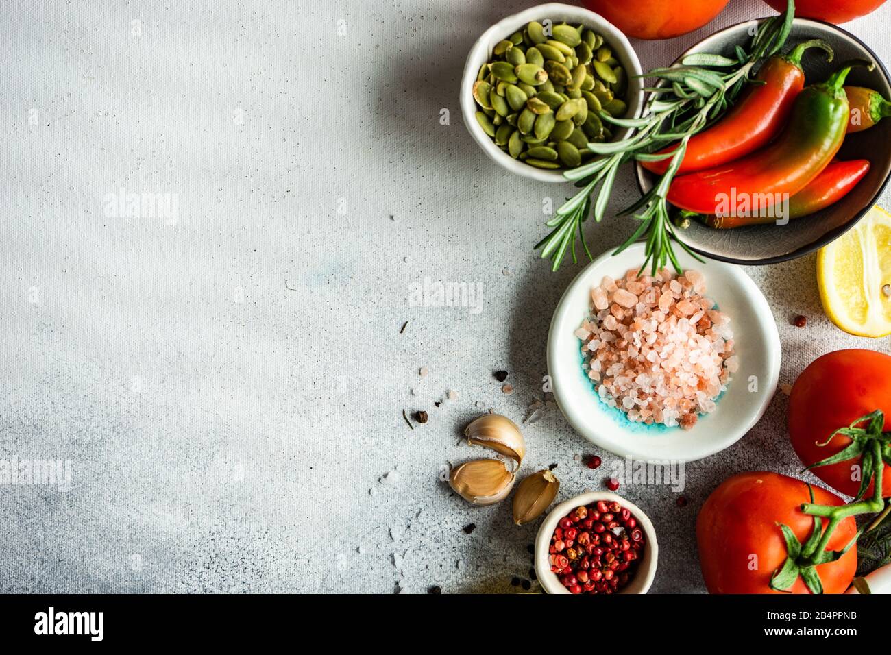 Organic food frame with spices and vegetables on stone background with ...