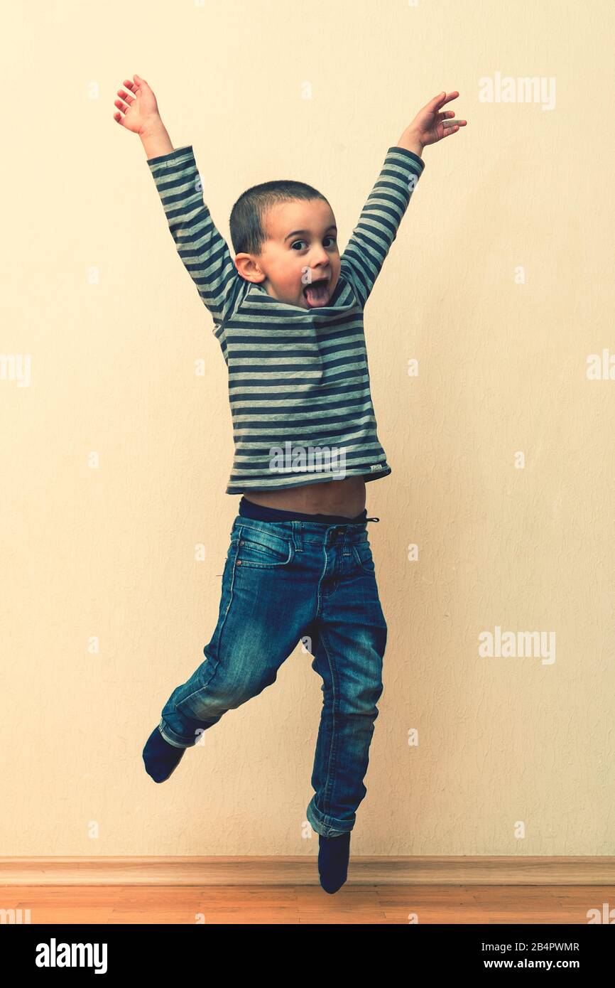 boy laying in the house. children playing at home. jumping children ...