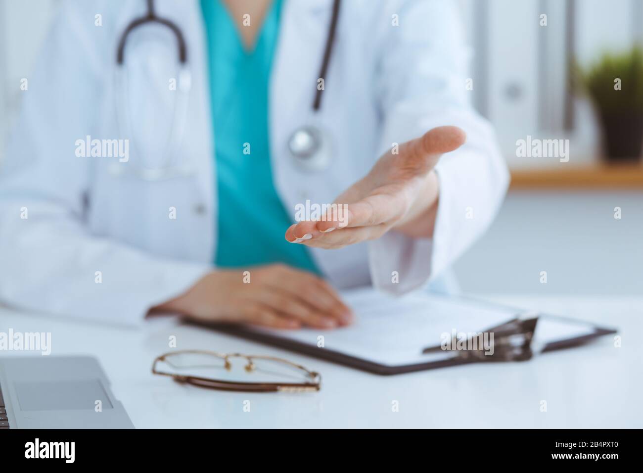 Female medicine doctor offering helping hand in office closeup ...