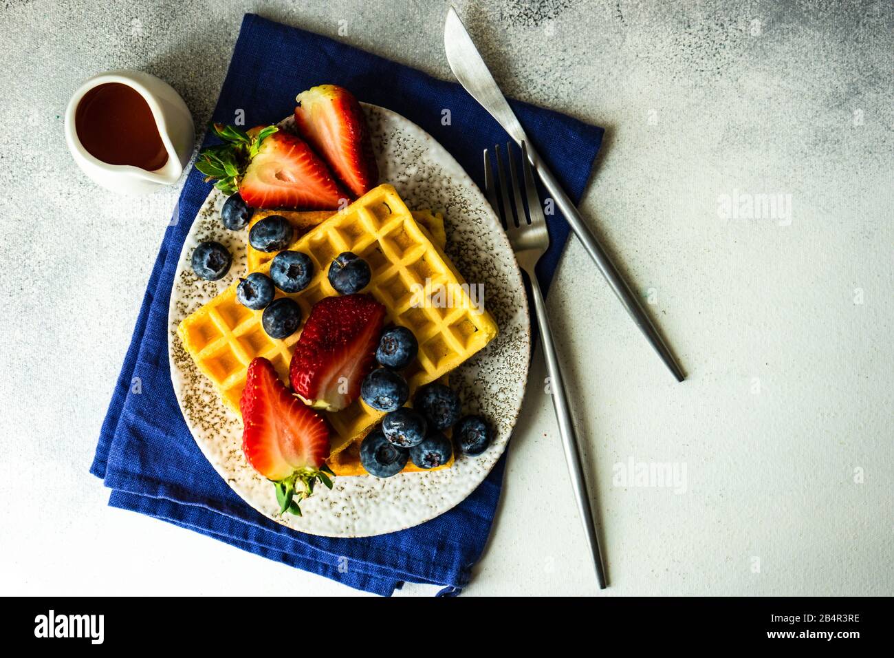 Traditional european breakfast with waffles, organic strawberry and ...