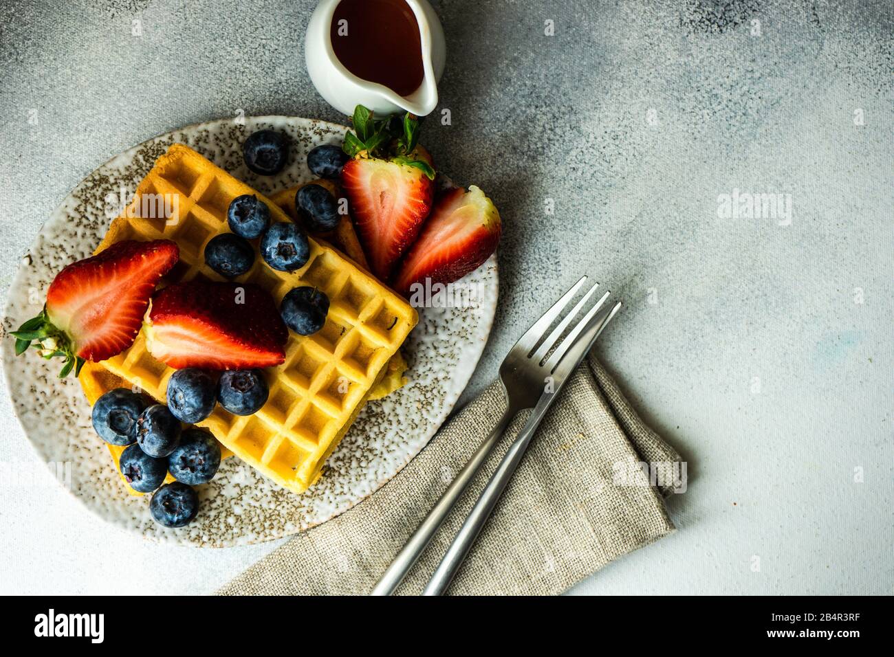 Traditional european breakfast with waffles, organic strawberry and ...