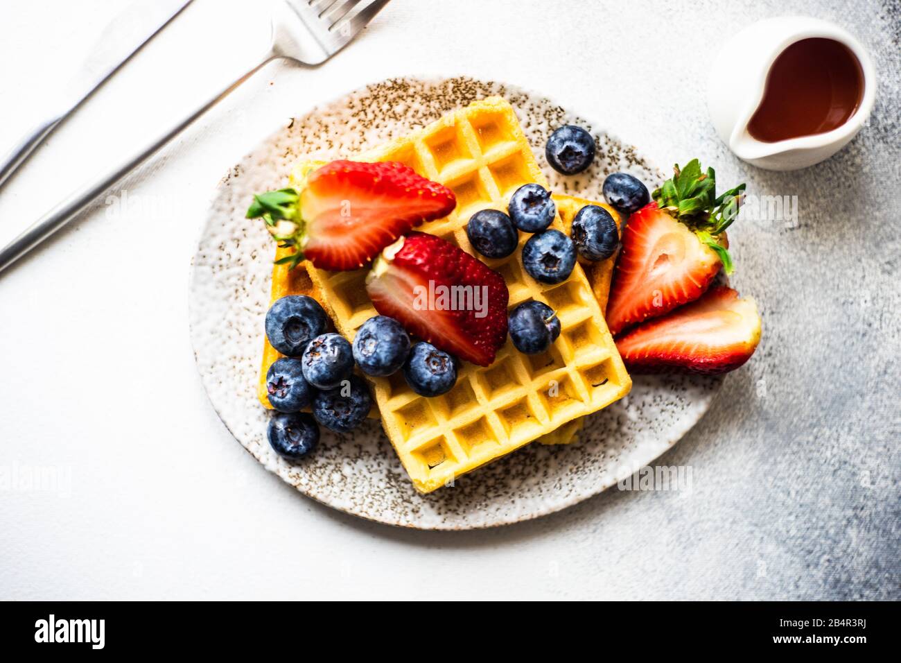Traditional european breakfast with waffles, organic strawberry and ...