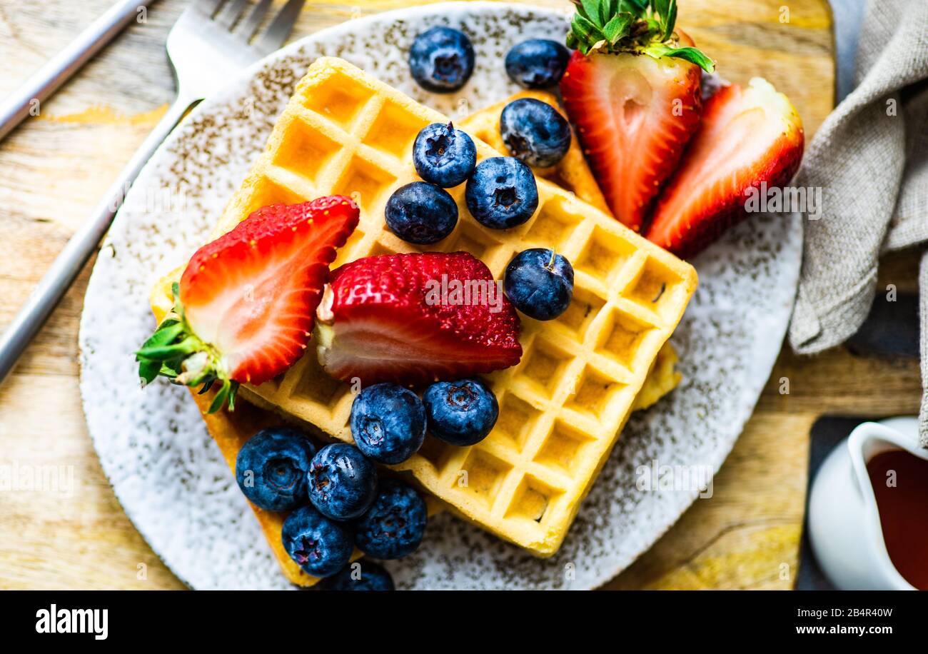 Traditional european breakfast with waffles, organic strawberry and ...