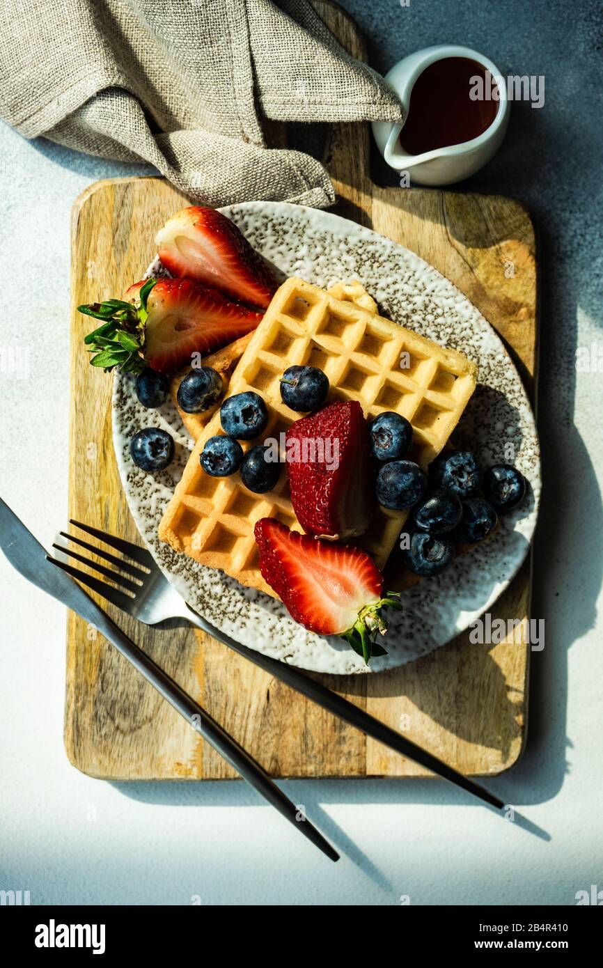 Traditional european breakfast with waffles, organic strawberry and ...