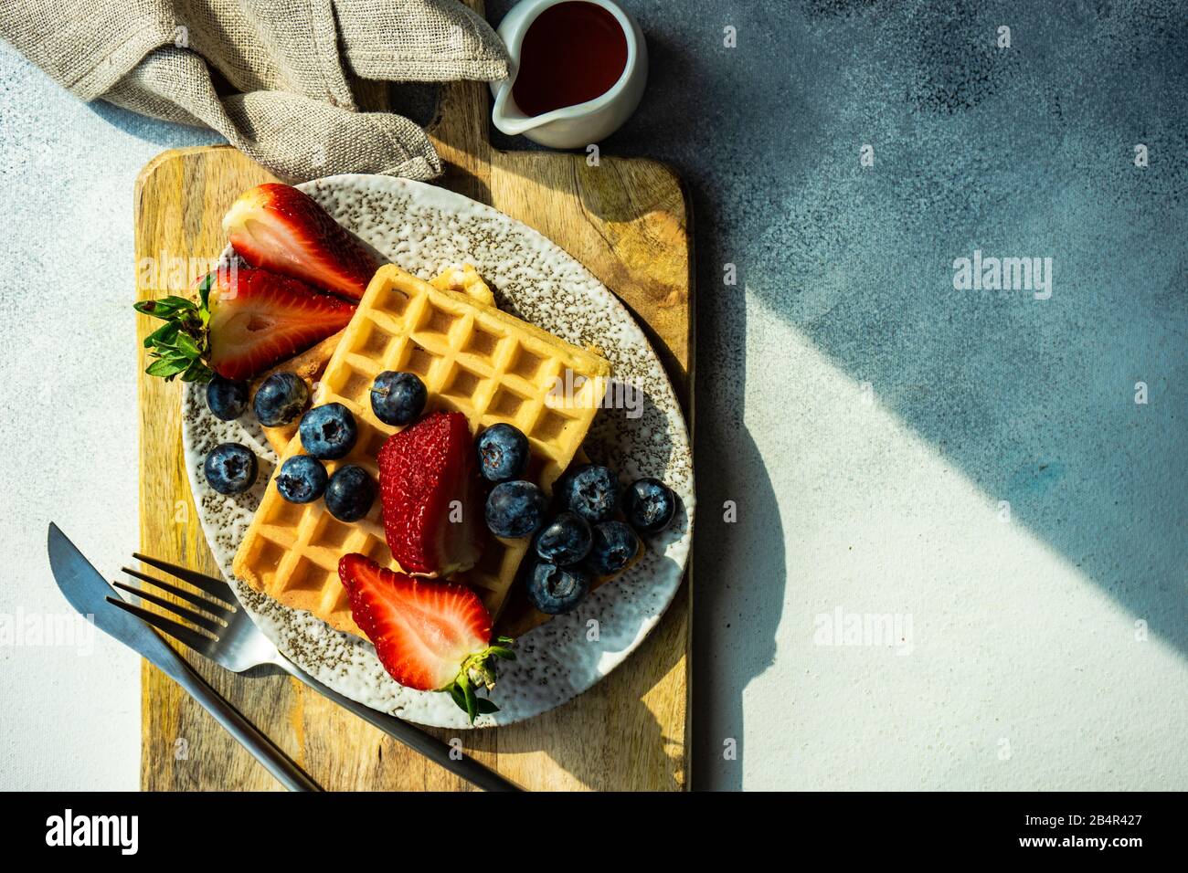 Traditional european breakfast with waffles, organic strawberry and ...