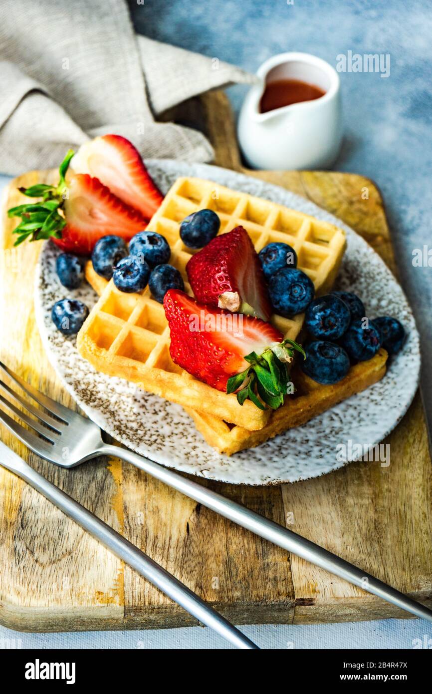 Traditional european breakfast with waffles, organic strawberry and ...