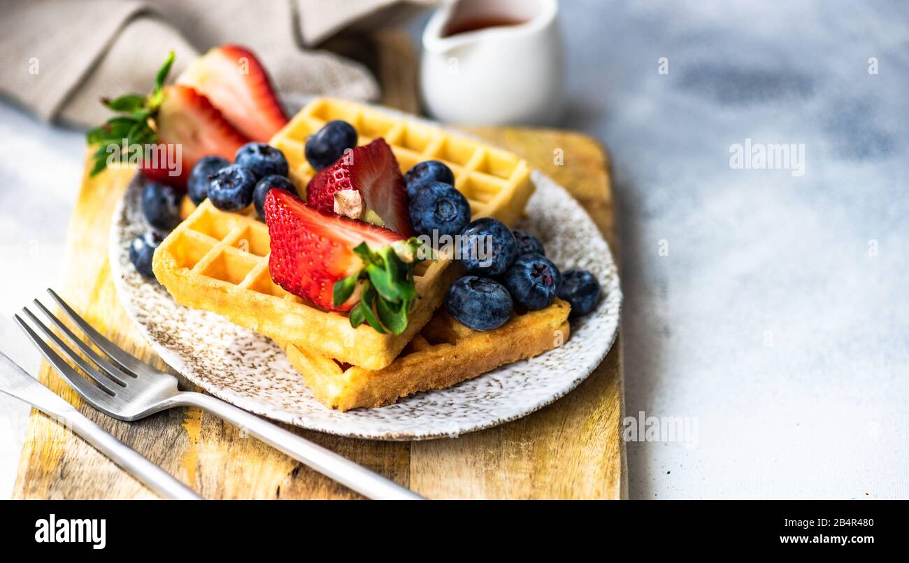 Traditional european breakfast with waffles, organic strawberry and ...