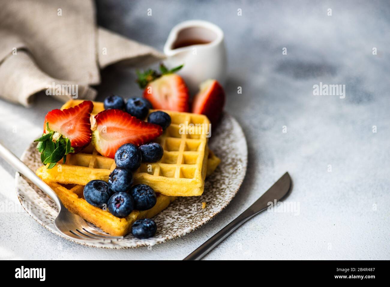 Traditional european breakfast with waffles, organic strawberry and ...