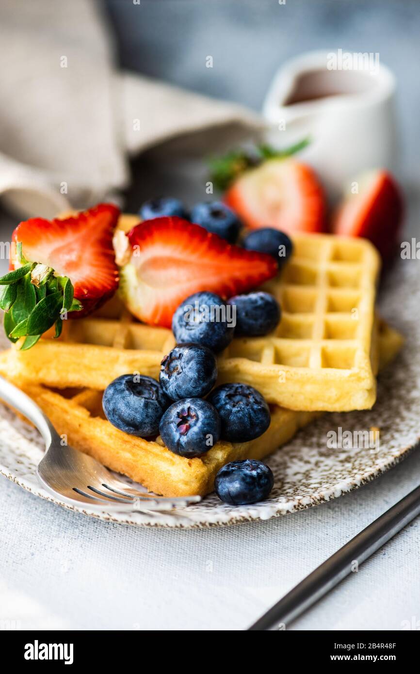 Traditional european breakfast with waffles, organic strawberry and ...