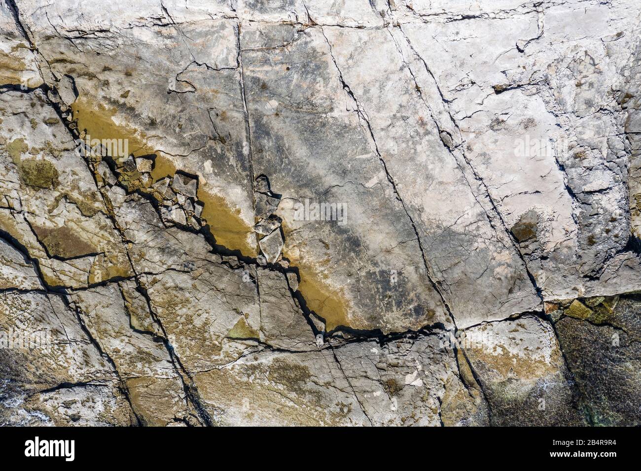 an aerial view of flat cracked rocky cliffs near sea, Duga Uvala ...