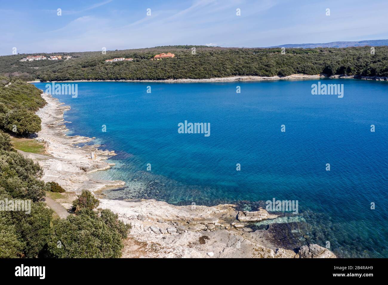 an aerial view of beautiful beach and clear calm sea in Duga Uvala ...